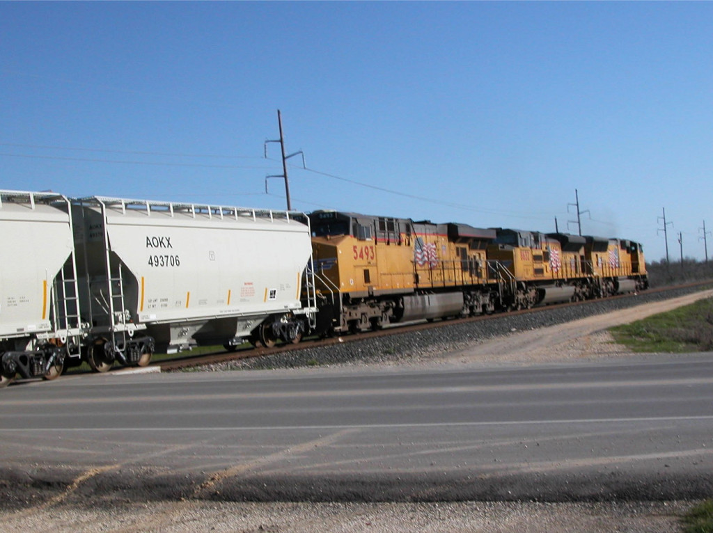 UP 5493 5Mar2012 #3 NB across McCarty Lane with Covered Hoppers